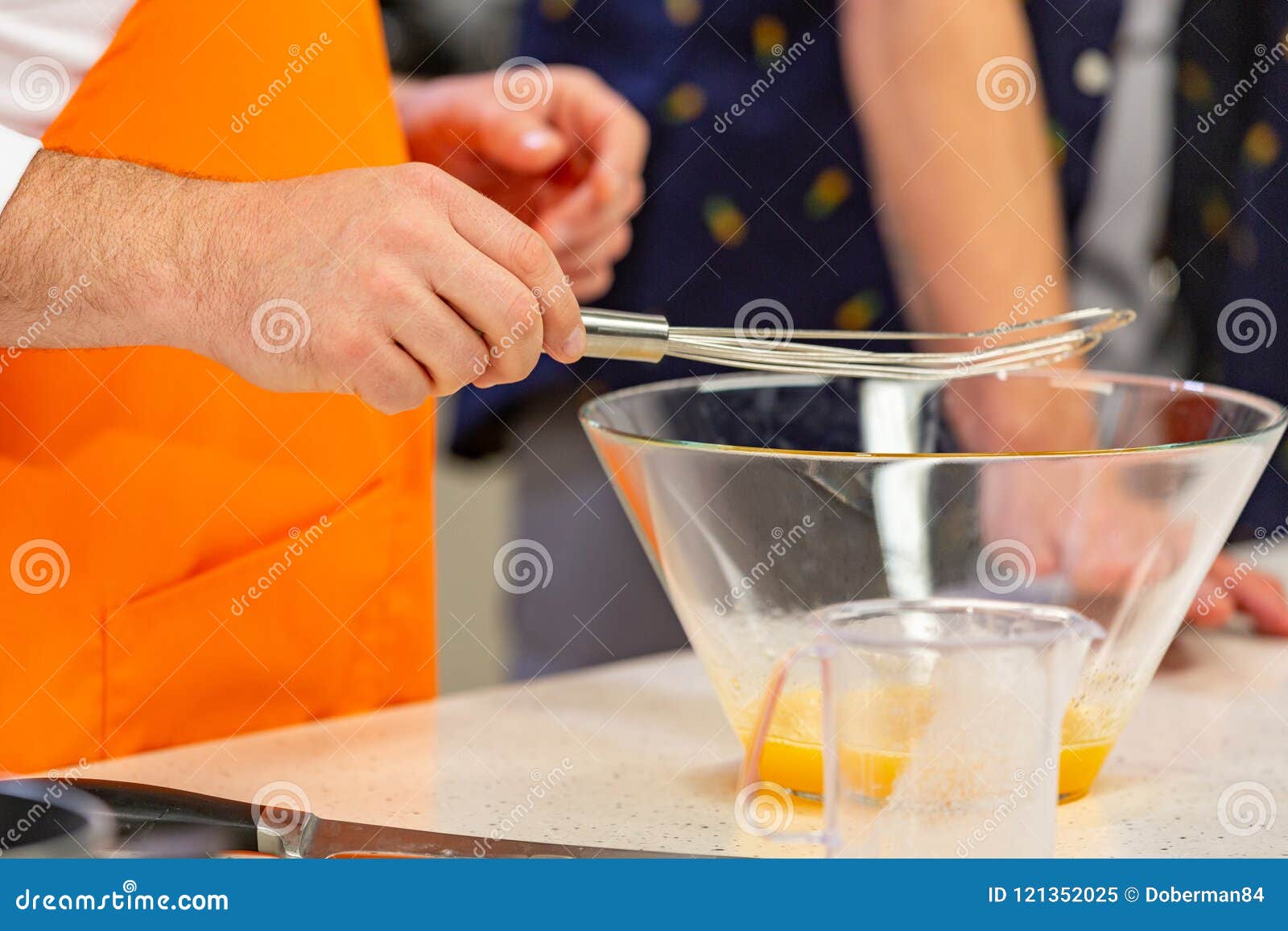 Kitchen Preparation: the Chef Beating Eggs in a Bowl with a Whisk ...