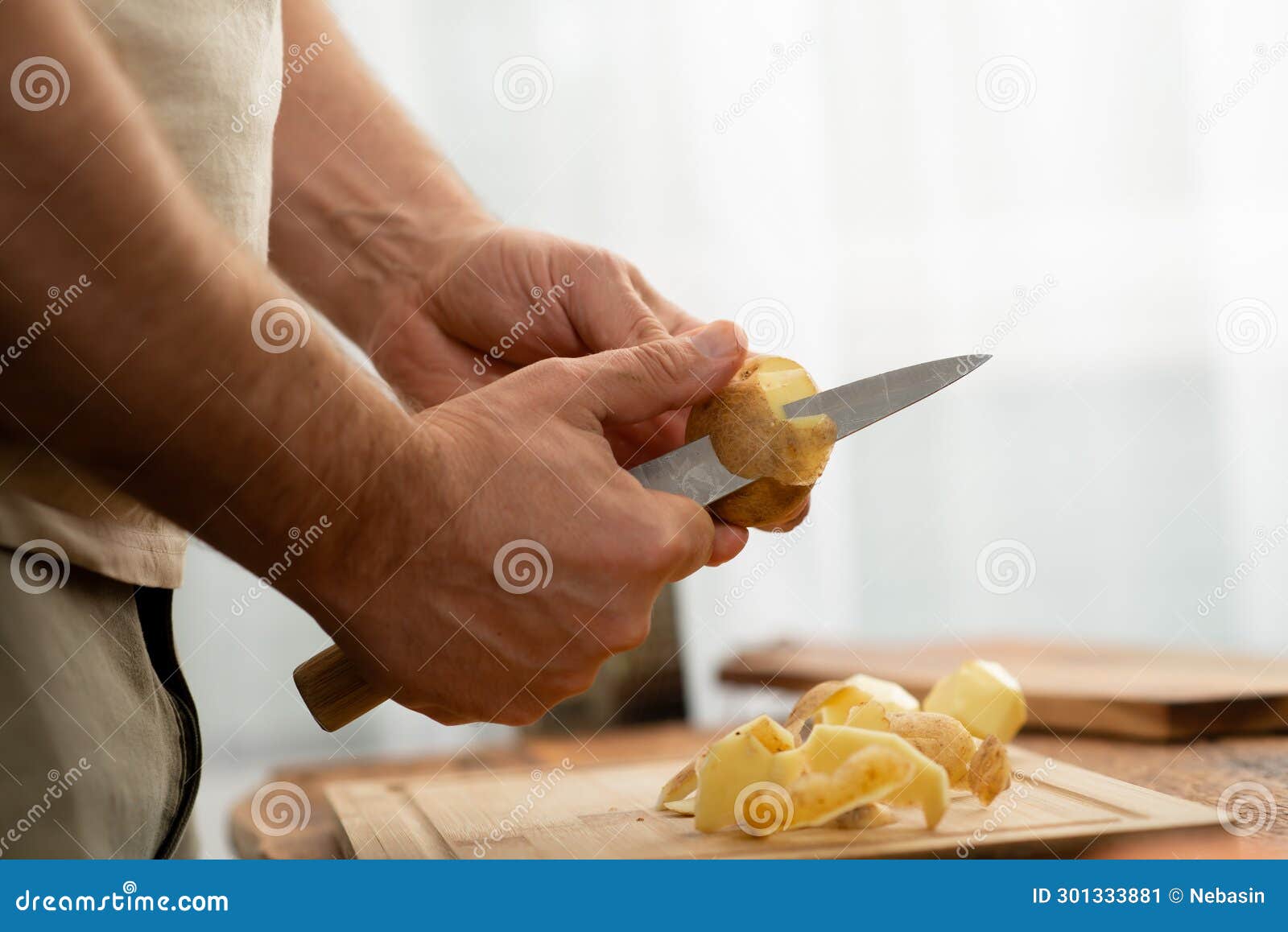 Kitchen Routine: Removing Potato Skin with a Sharp Peeler. Stock Image ...