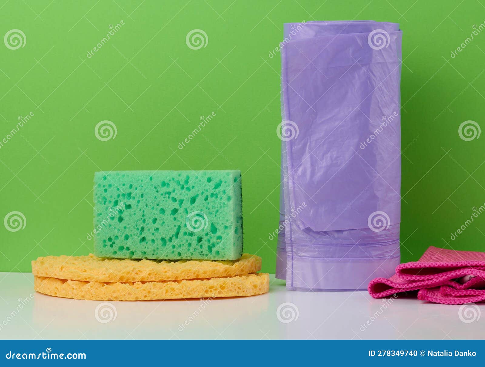 Kitchen Sponge, Rag and Plastic Bag Roll on Green Background Stock ...