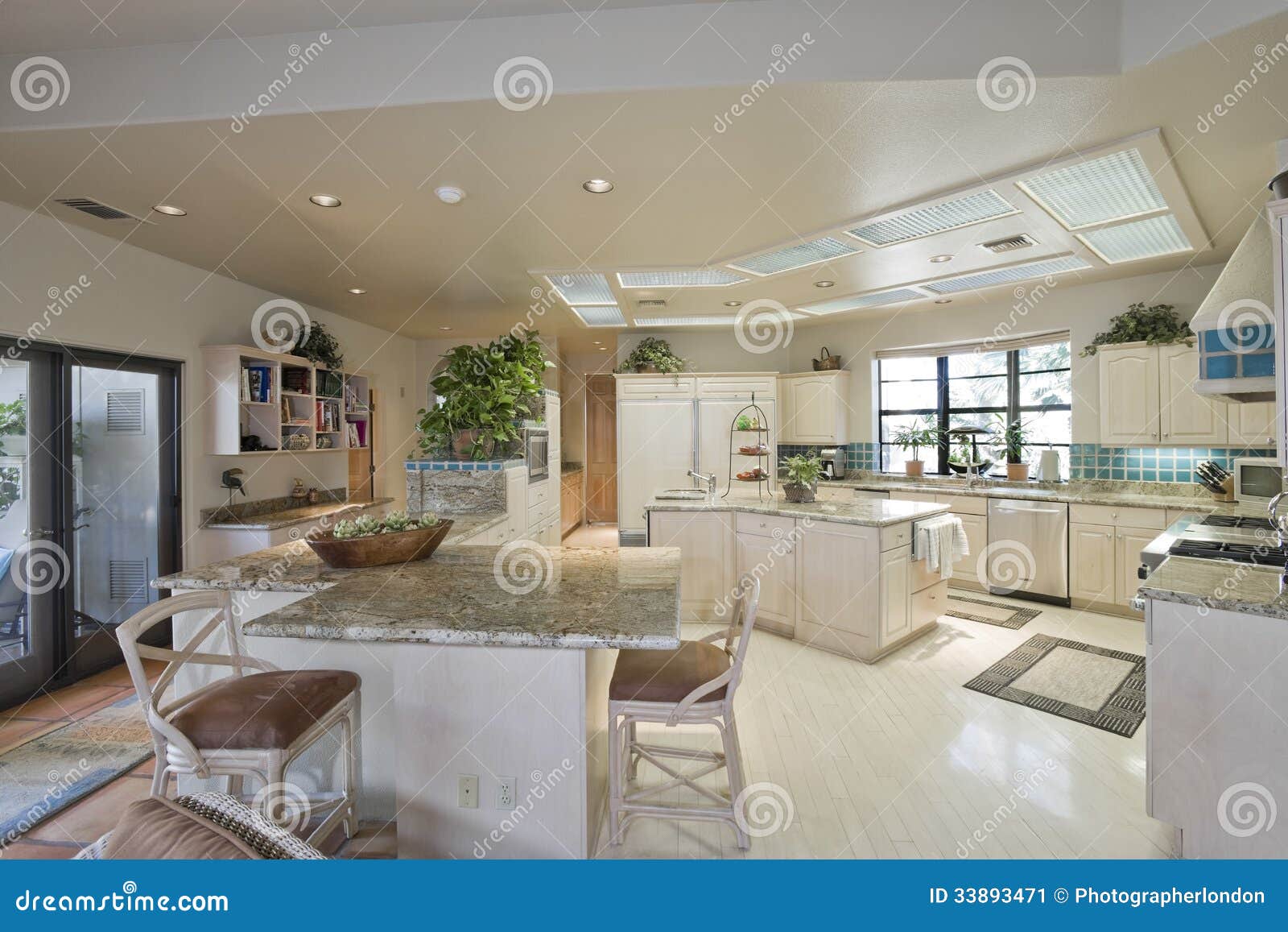 Kitchen with Stools at Island in House Stock Image - Image of ...