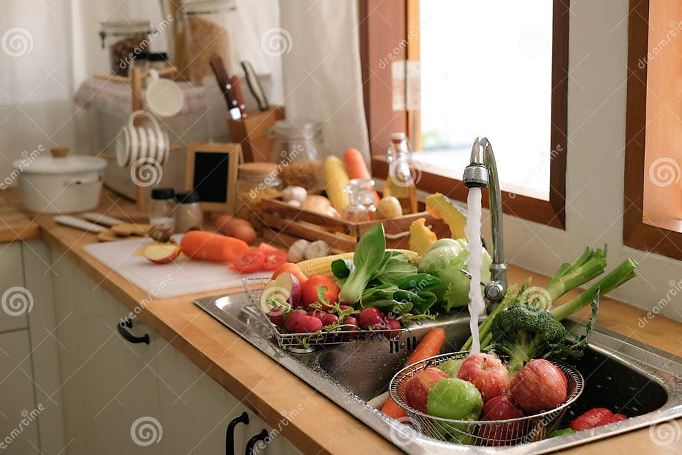 Kitchen Tap is Opened so the Water Flows into Vegetables and Fruits To ...