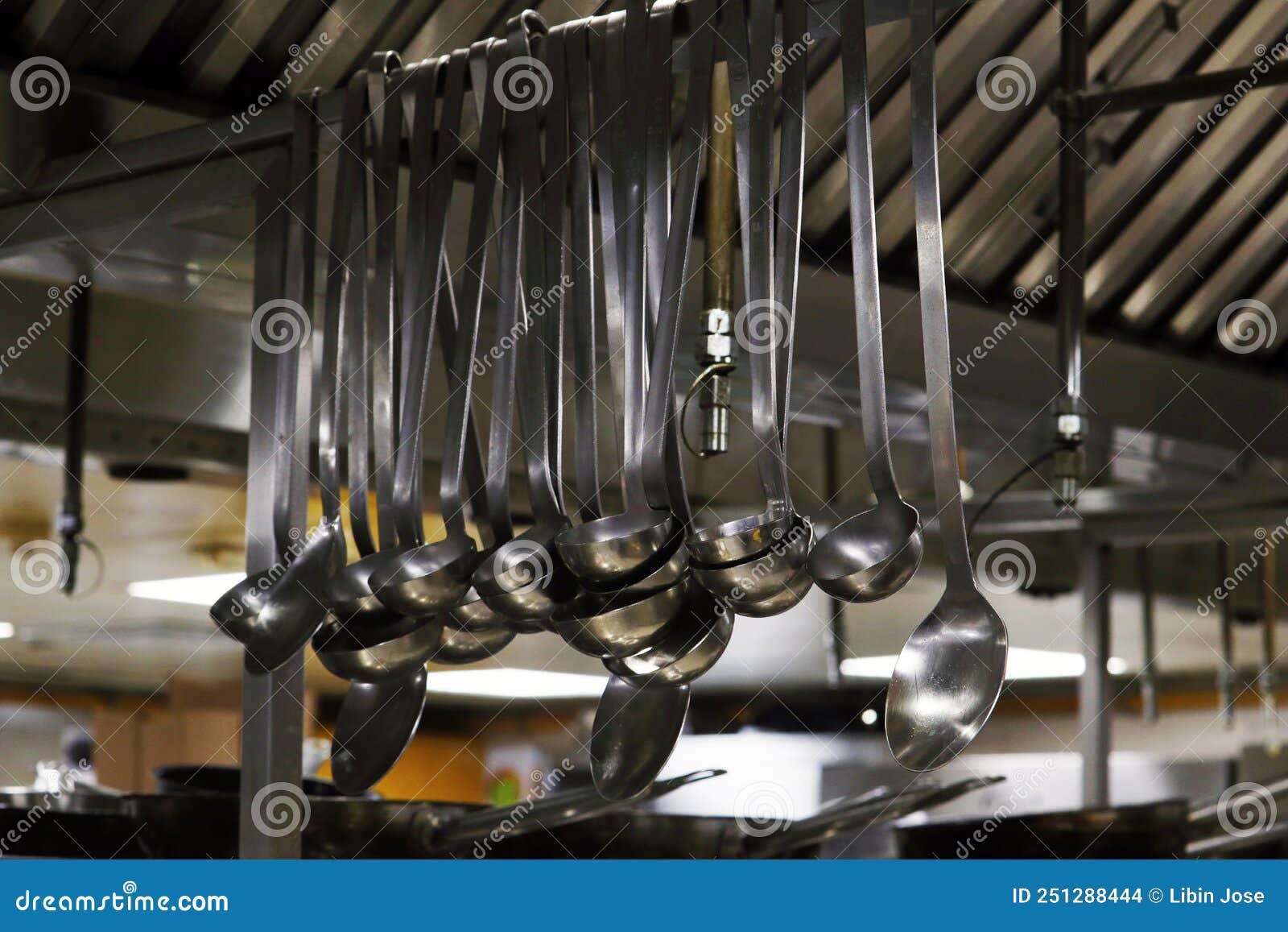 Kitchen Utensils Like Ladles and Spatulas Hanging on a Rail Editorial ...