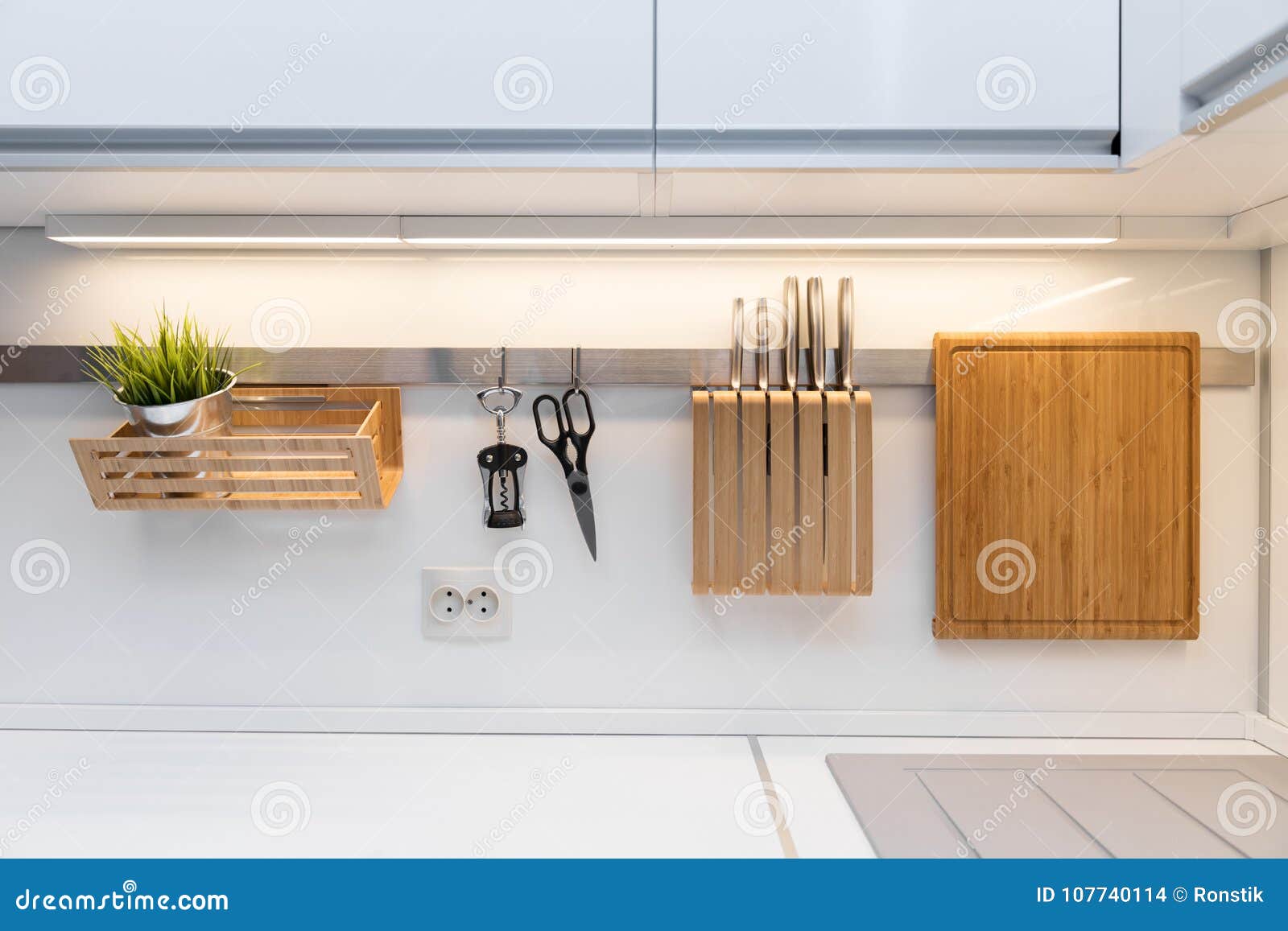 Kitchenware Hanging on the Rail in the White Glossy Kitchen Stock Photo ...