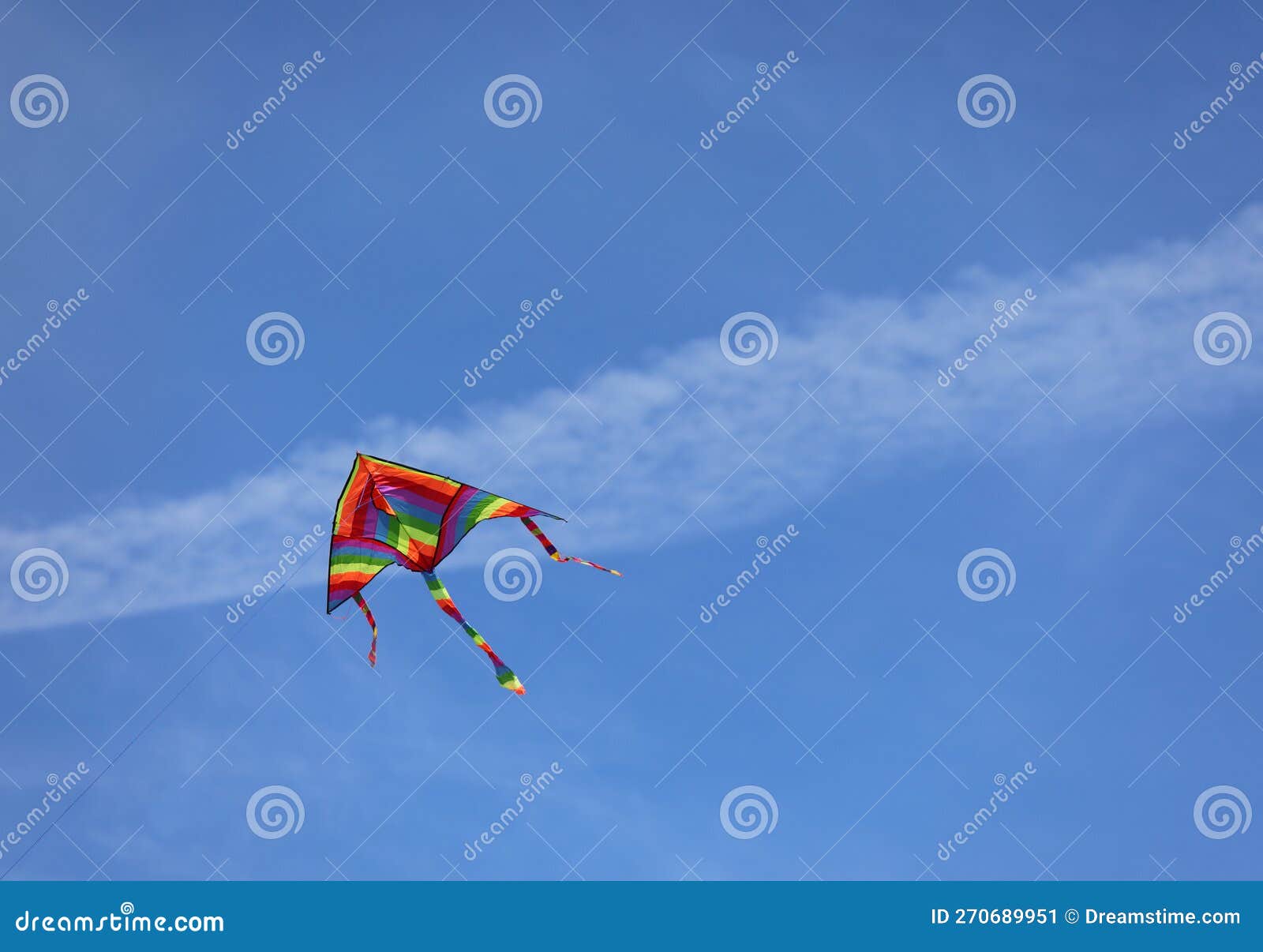 Kite with Rainbow Colors Flies Tied on String in the Blue Sky Stock ...