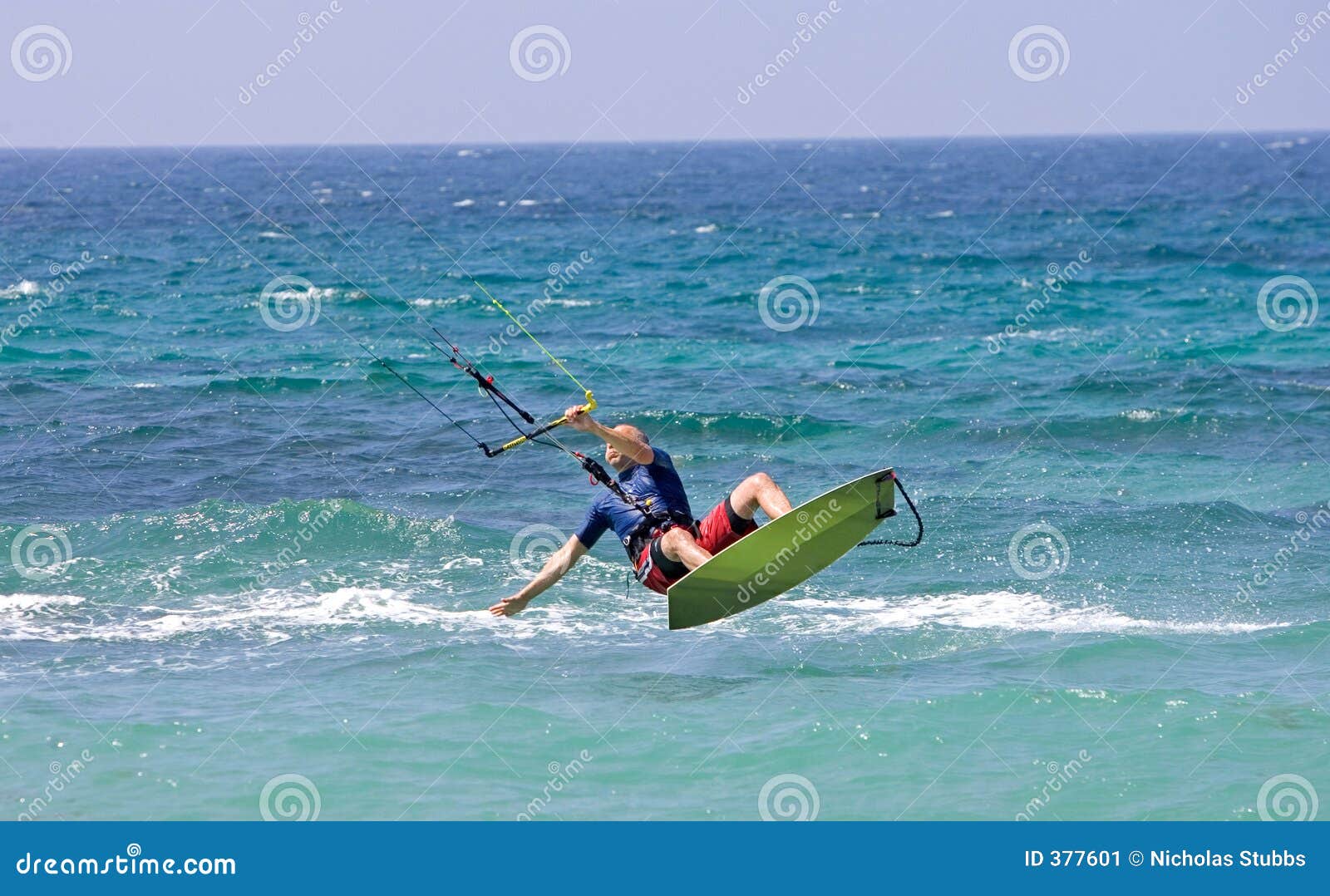 Kitesurfer Flying through the Air on a Sunny Beach Stock Image - Image ...