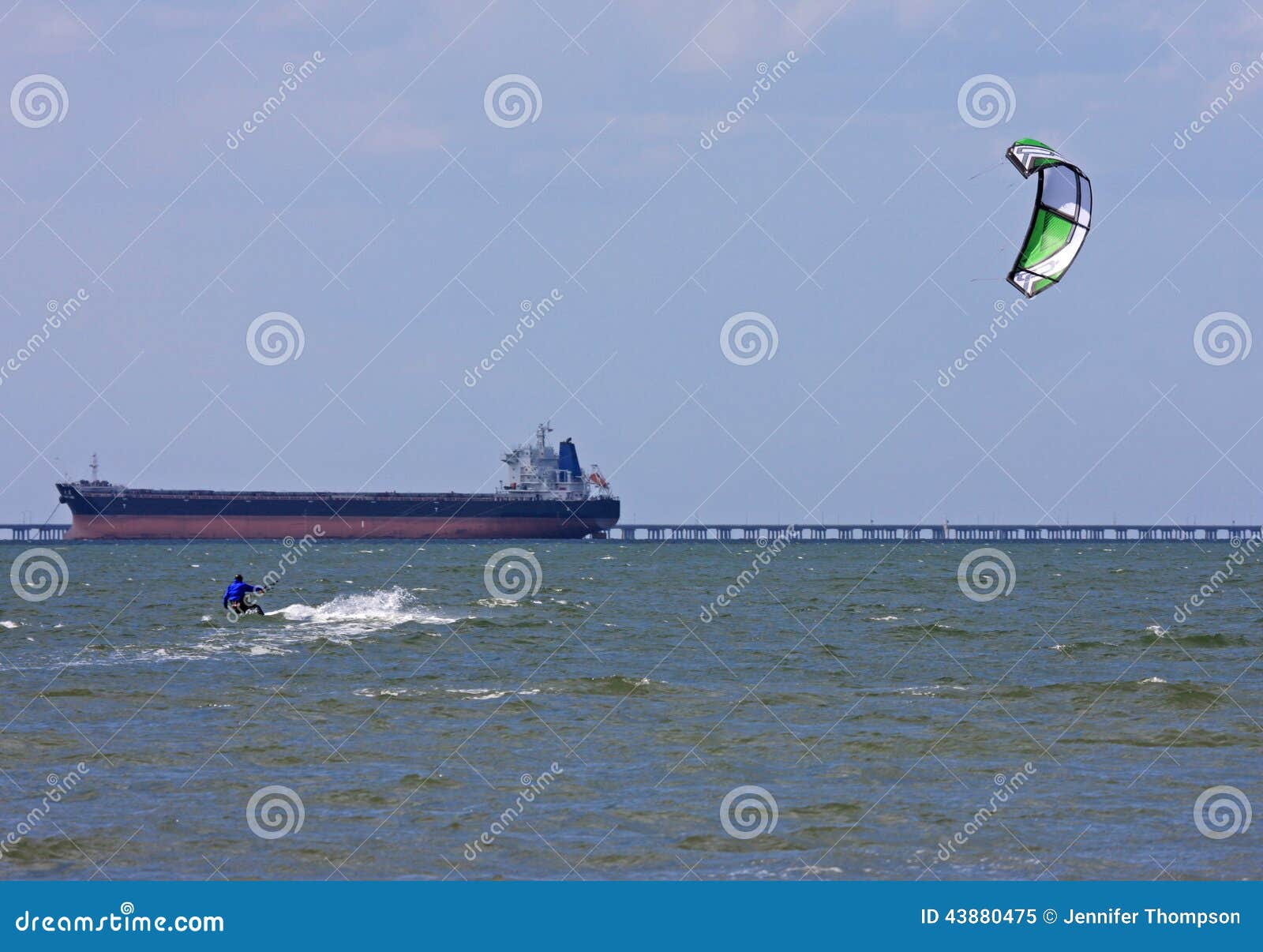Kitesurfer and Tanker stock image. Image of board, kite - 43880475