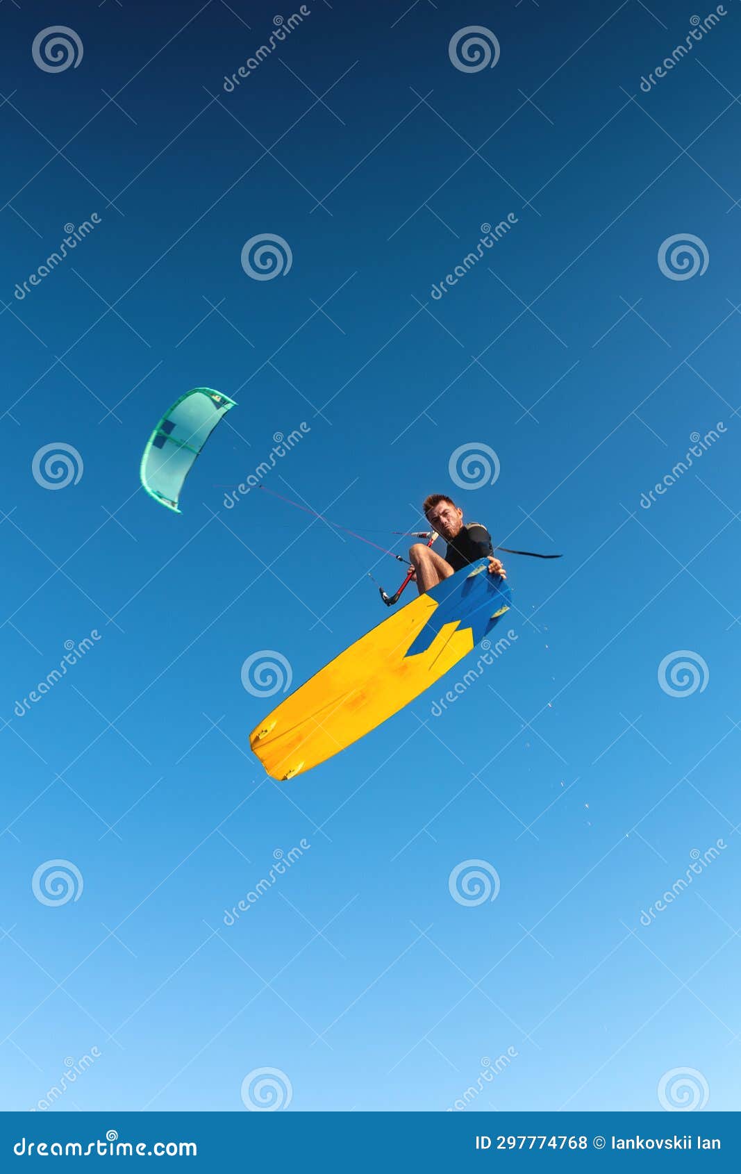 Kitesurfing, Professional Rider Flying Performing a Trick, Looking at ...