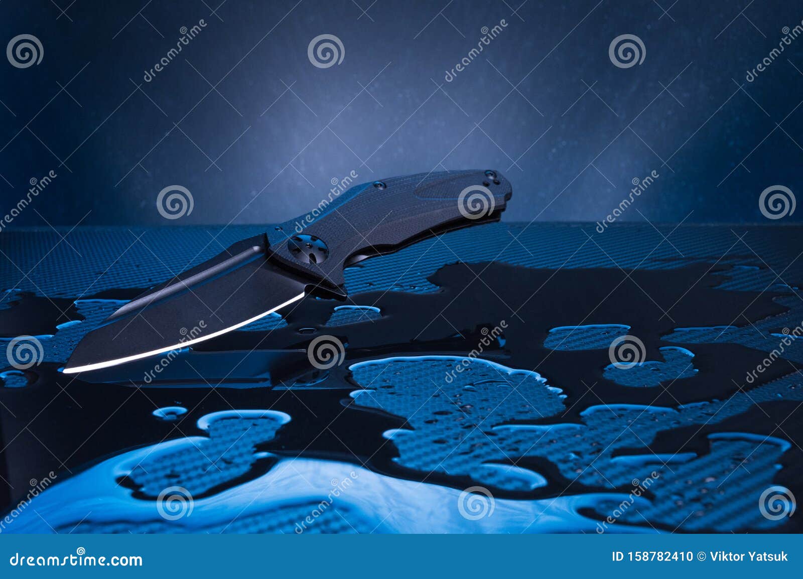 Knife with a Black Blade and Handle. Knife and Spilled Water Stock ...
