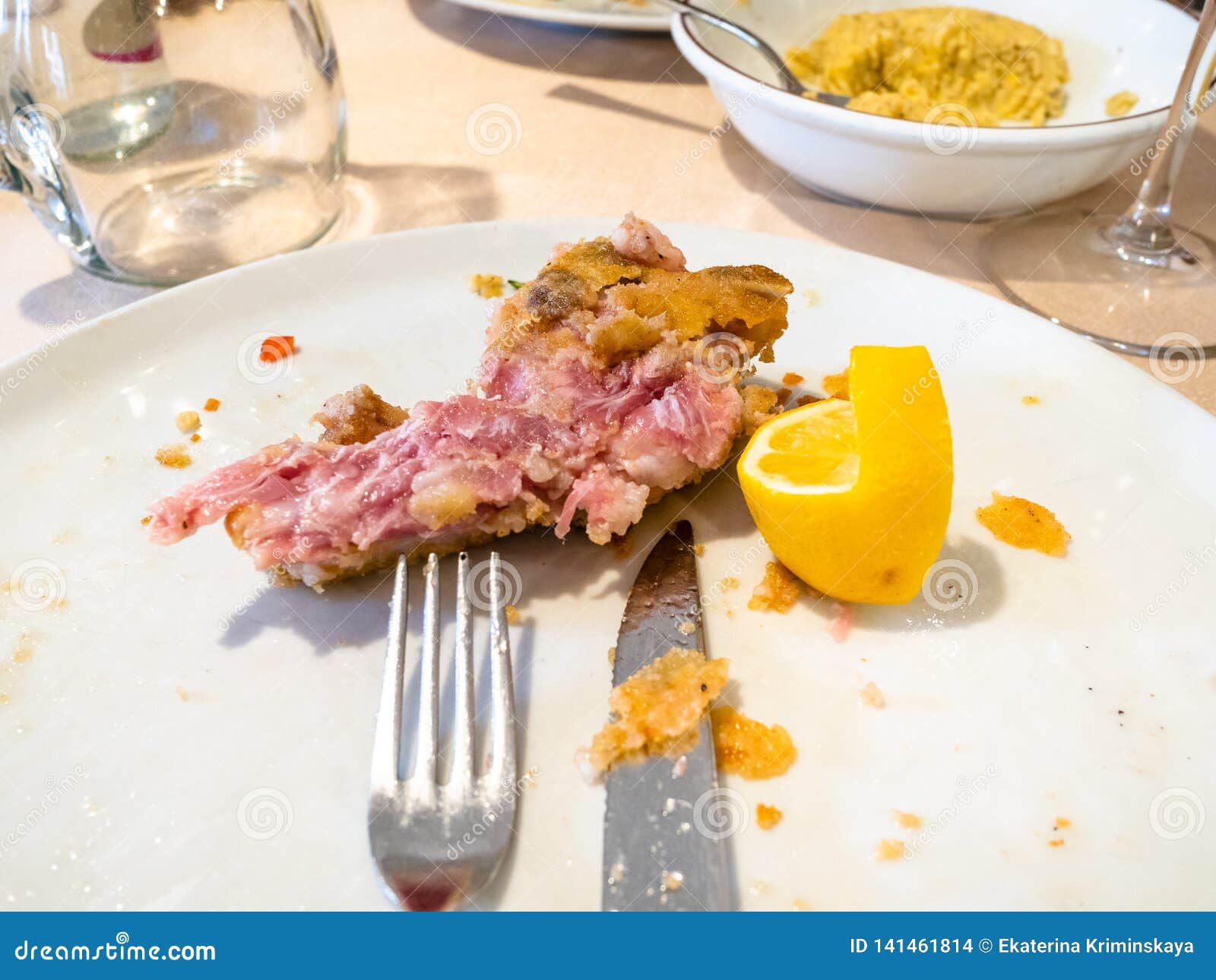 Knife with Fork and Gnawed Bone on Plate Stock Photo - Image of bergamo ...
