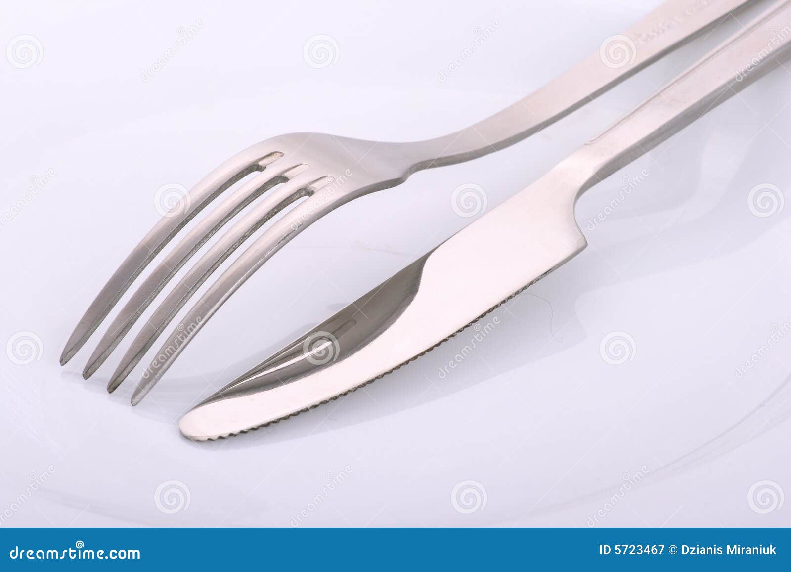 Knife and plug on a plate stock image. Image of knife - 5723467