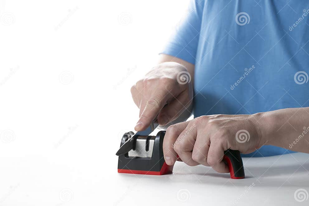 A Knife Sharpener. a Man Sharpens a Knife on a Special Universal Knife ...