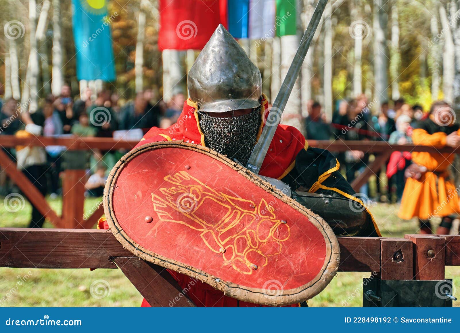 Knight in Armor with Shield and Sword Leaned Against the Wooden Railing ...