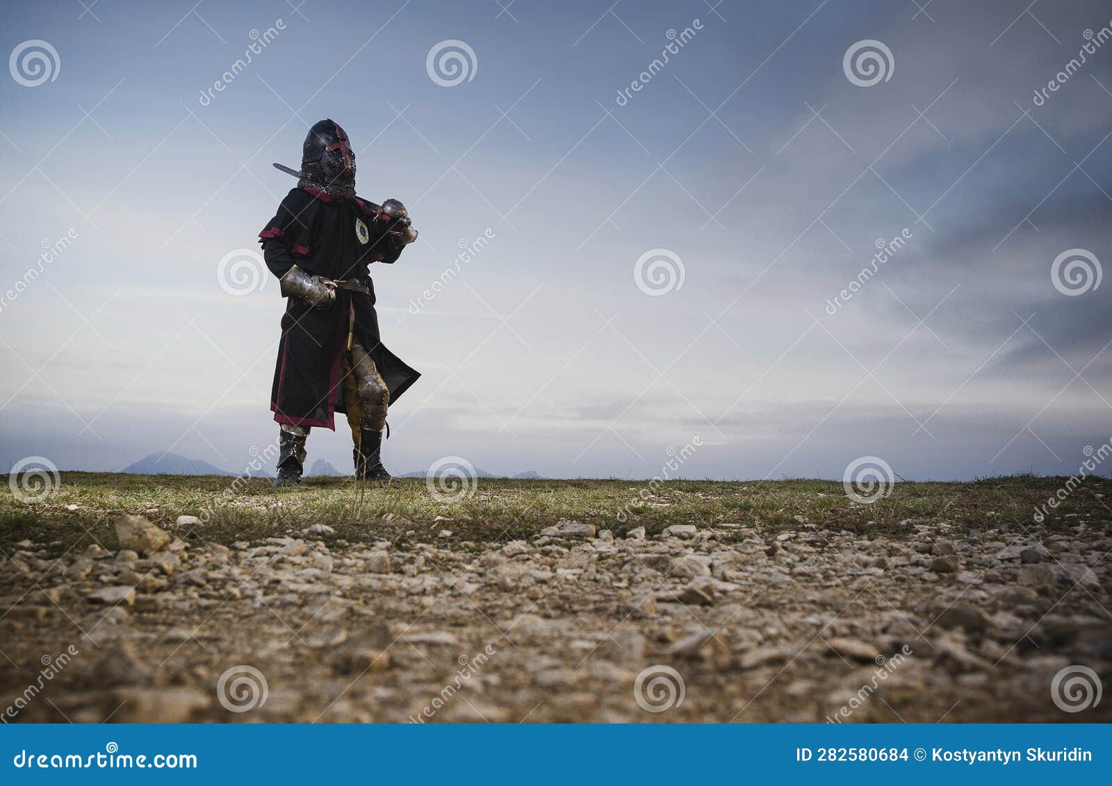 Knight in Armor with a Sword on His Shoulder Stock Photo - Image of ...