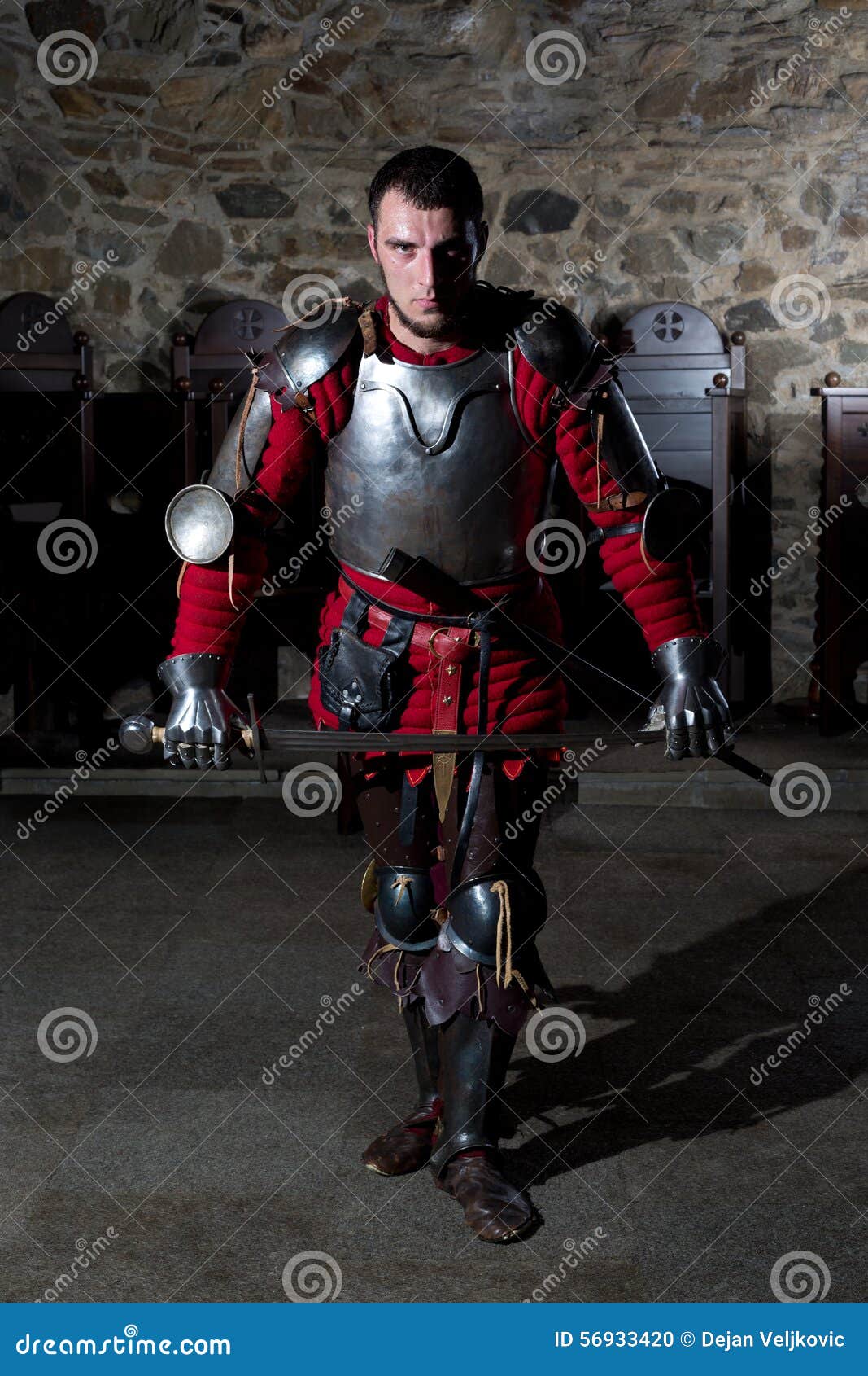 Knight in Armor with Sword Standing in Old Church and Looking at Camera ...