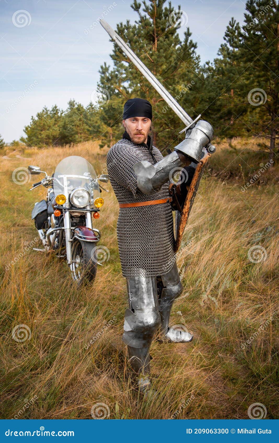 Knight in Chainmail with a Shield and a Sword in His Hands Stands ...
