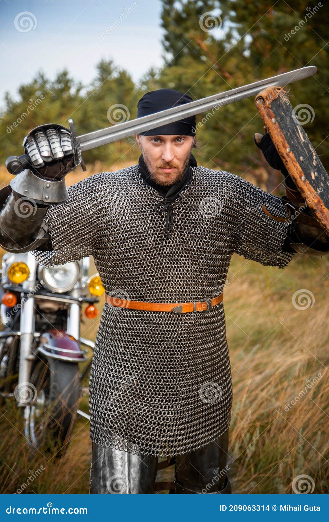 Knight in Chainmail with a Shield and a Sword in His Hands Stands ...