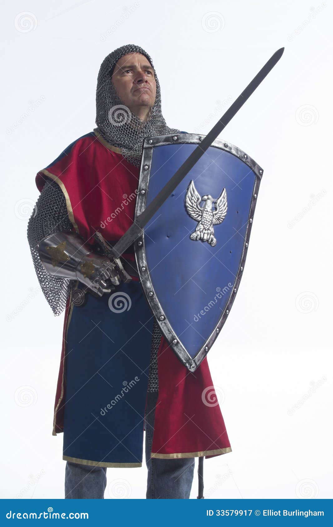 Knight in Full Armor with Shield and Sword Looking Up, Vertical Stock ...