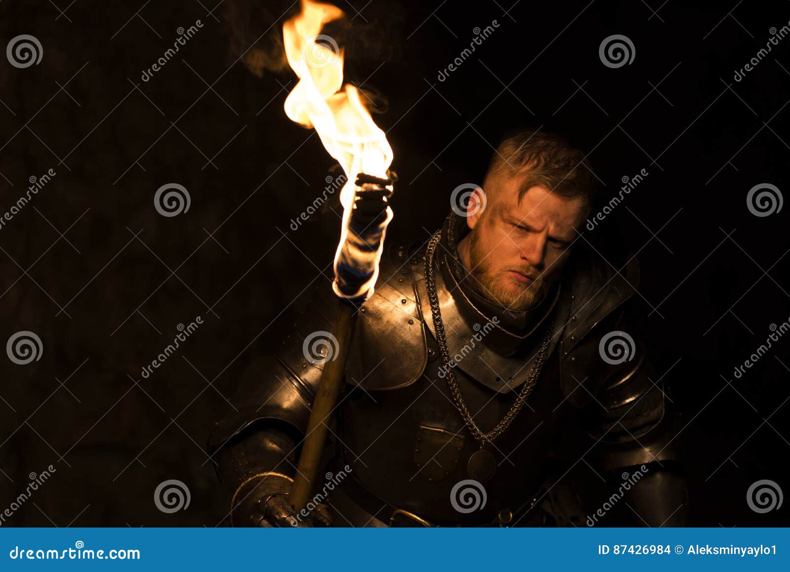 Knight with a Torch at Night on a Wall Background Stock Photo - Image ...