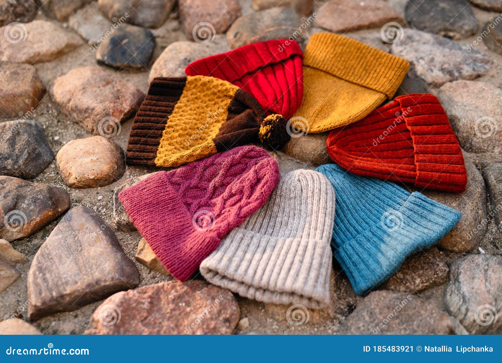 Knitted Hats of Different Colors Lie on Stone Surface, Large ...