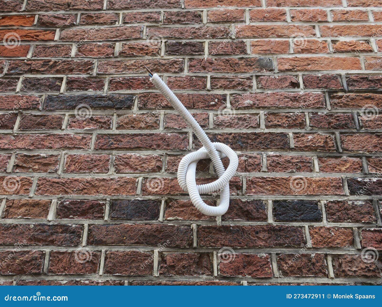 Knot of Electricity Cable Peeping Out of a Hole in a Brick Wall Stock ...
