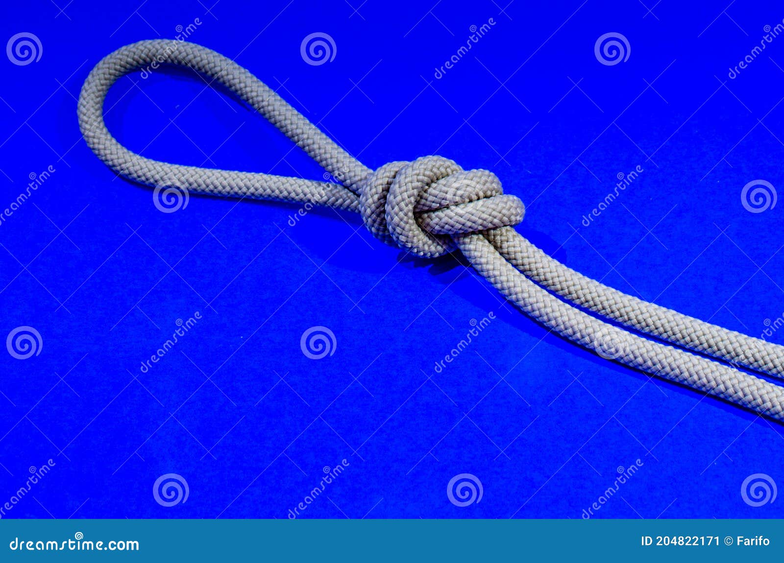Knot with Loop in Front of Blue Background Stock Image - Image of ...