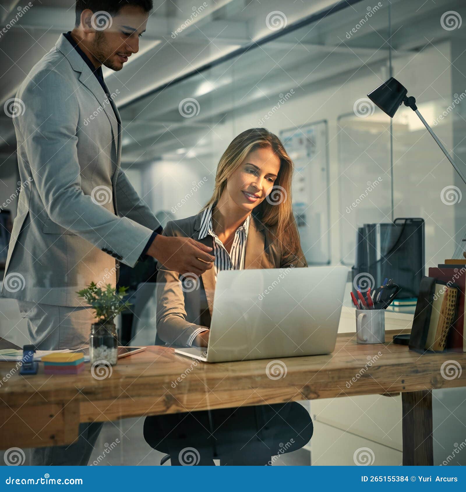 They Know the Value of Overtime. Colleagues Using a Laptop Together on ...