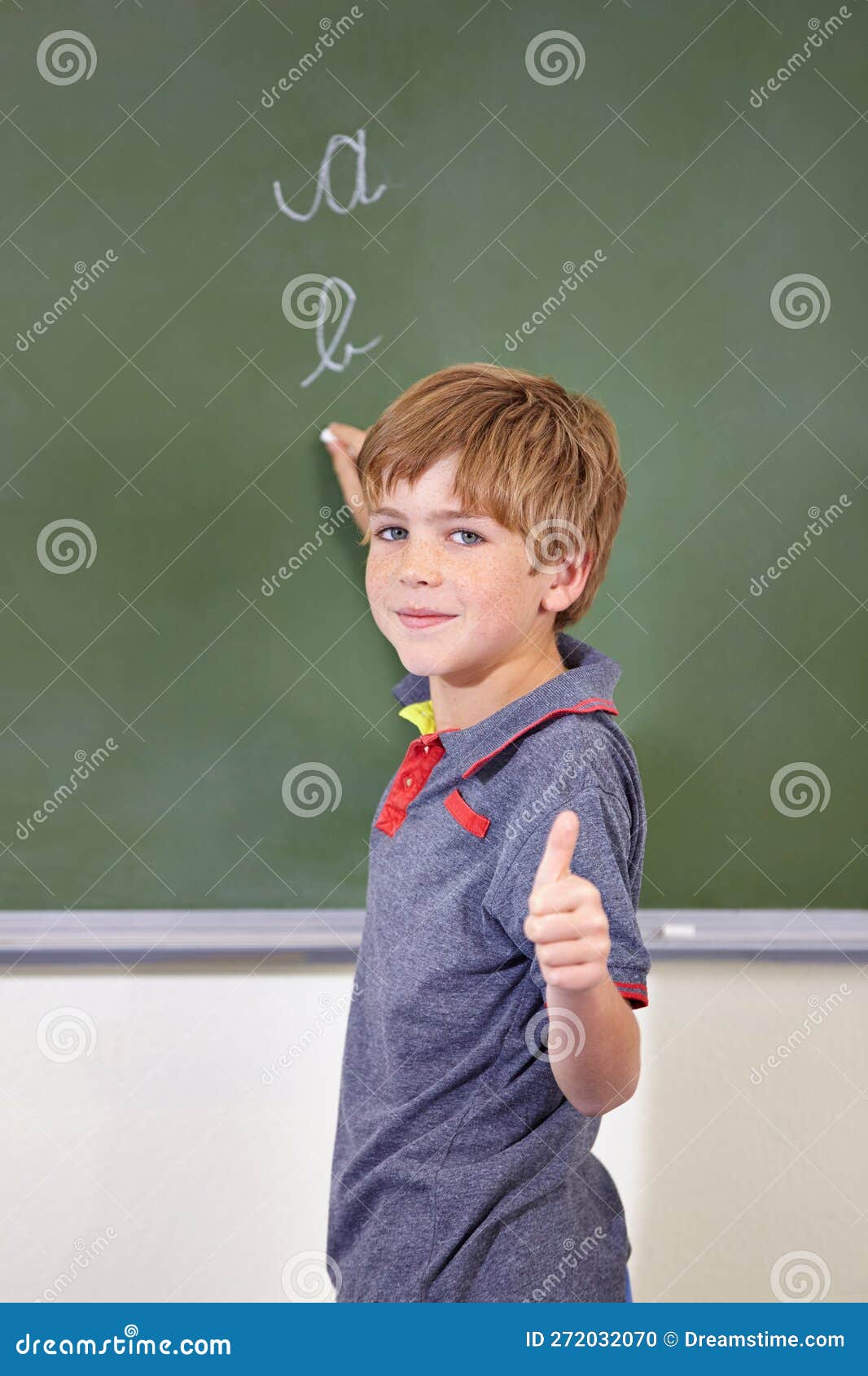 He Knows the Answer. a Young Boy Writing on the Blackboard at School ...