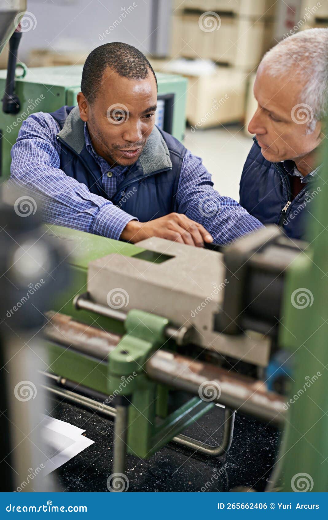 He Knows this Machinery Inside and Out. Two Men Working Over Factory ...