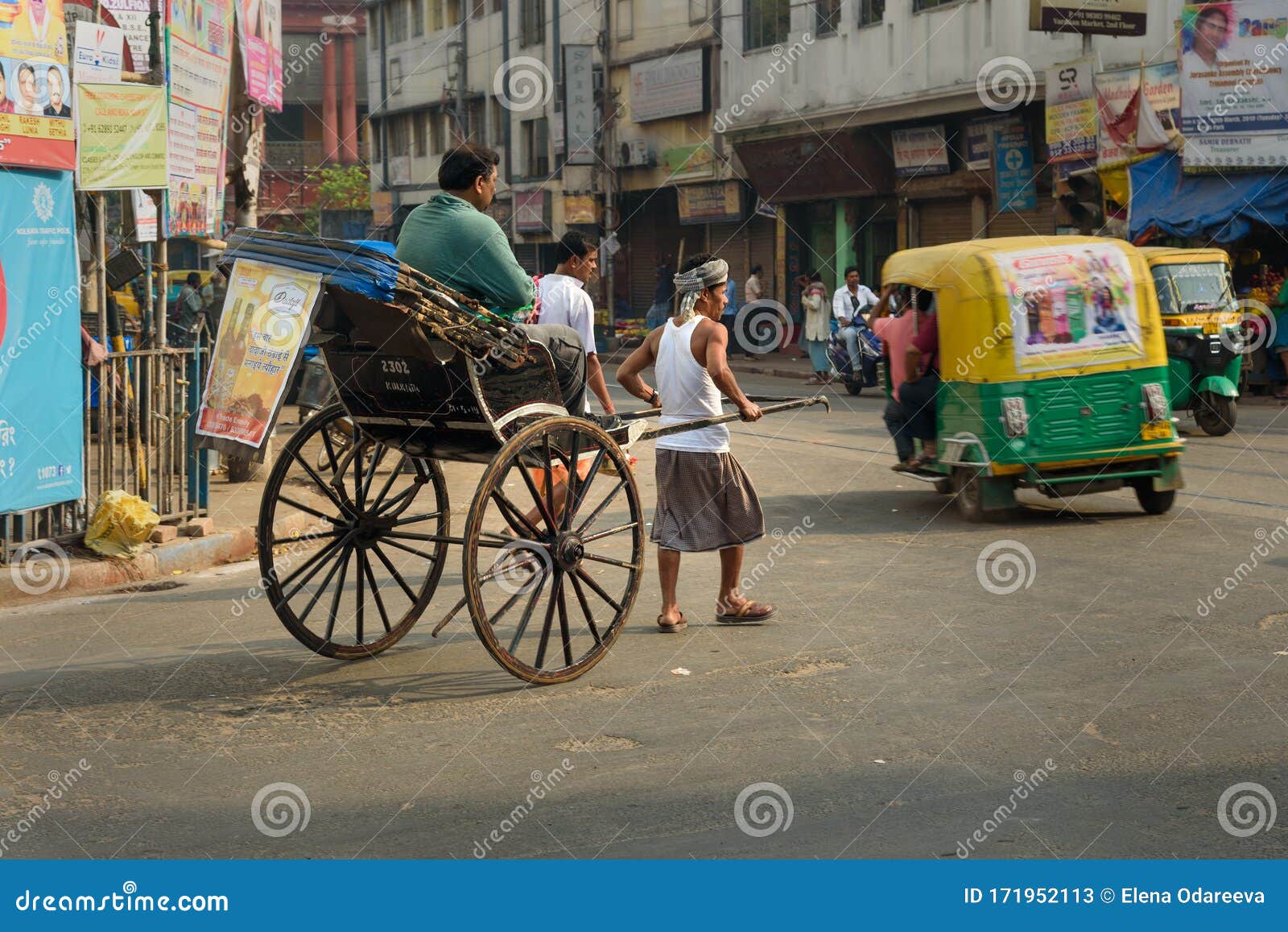 Man Rickshaw Puller is Pulling His Hand Rickshaw with Passenger on the ...