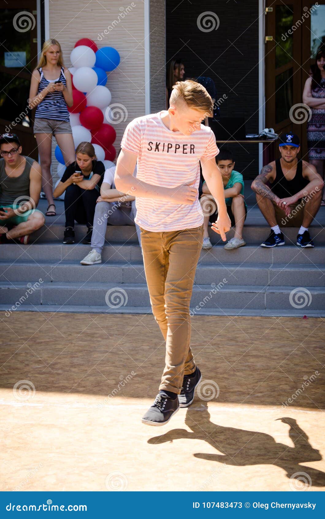A Boy Dancing a Break Dance in the Square with Spectators Editorial ...
