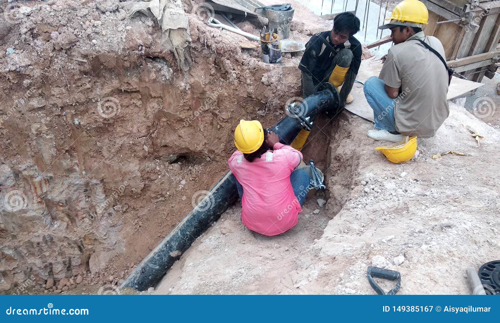 Construction Workers Repairing Underground Utility Services Pipe ...