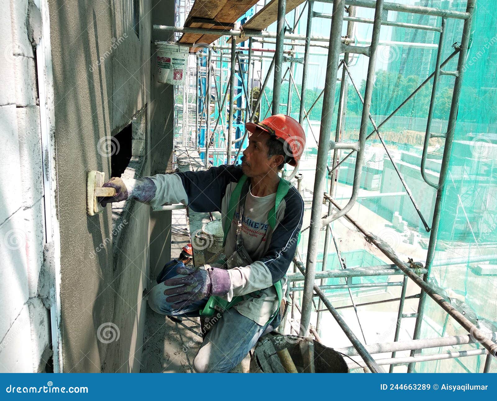 Construction Workers Plastering Wall Using Cement Plaster at the ...