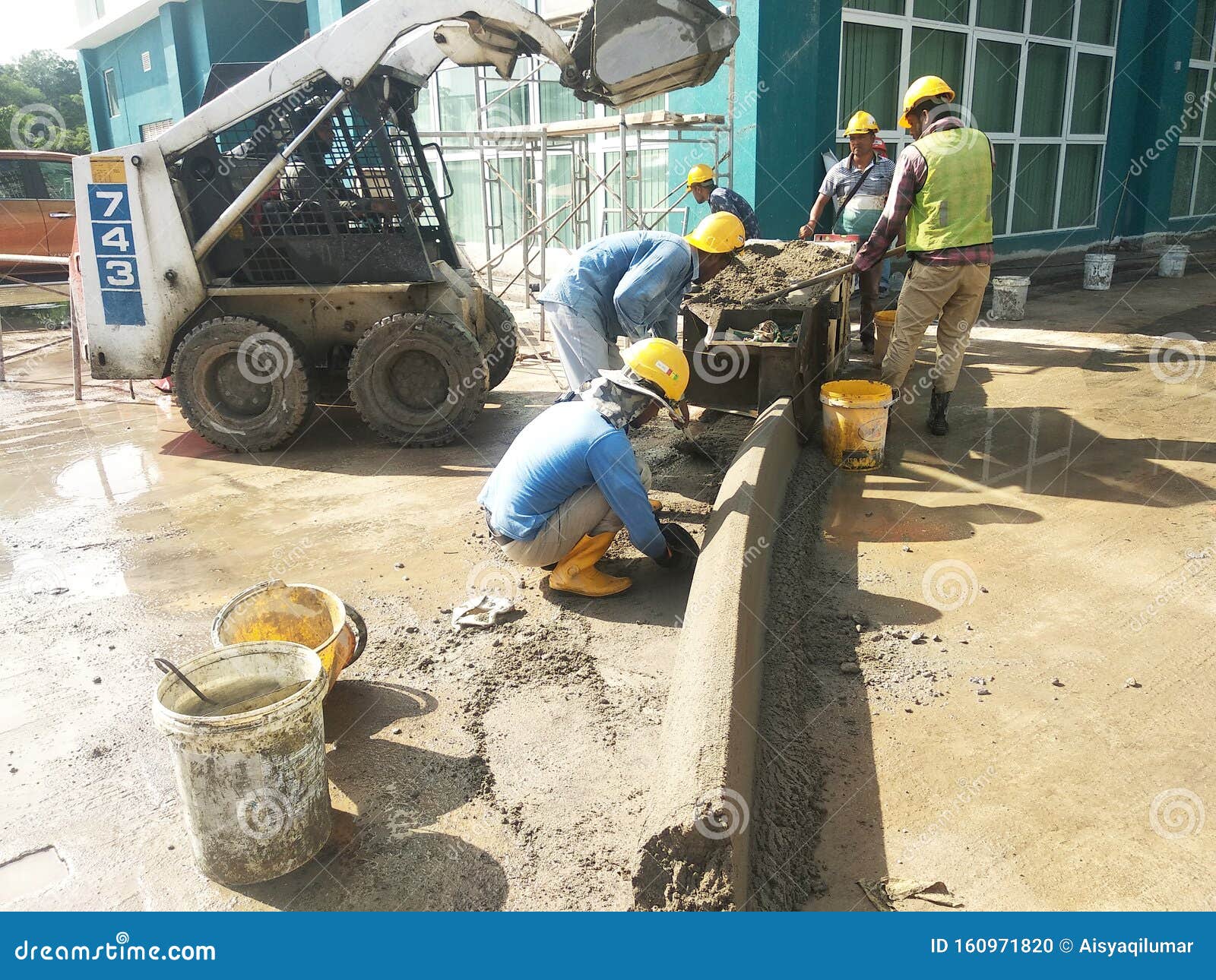 Construction Workers Creating Concrete Road Curb at the Construction ...