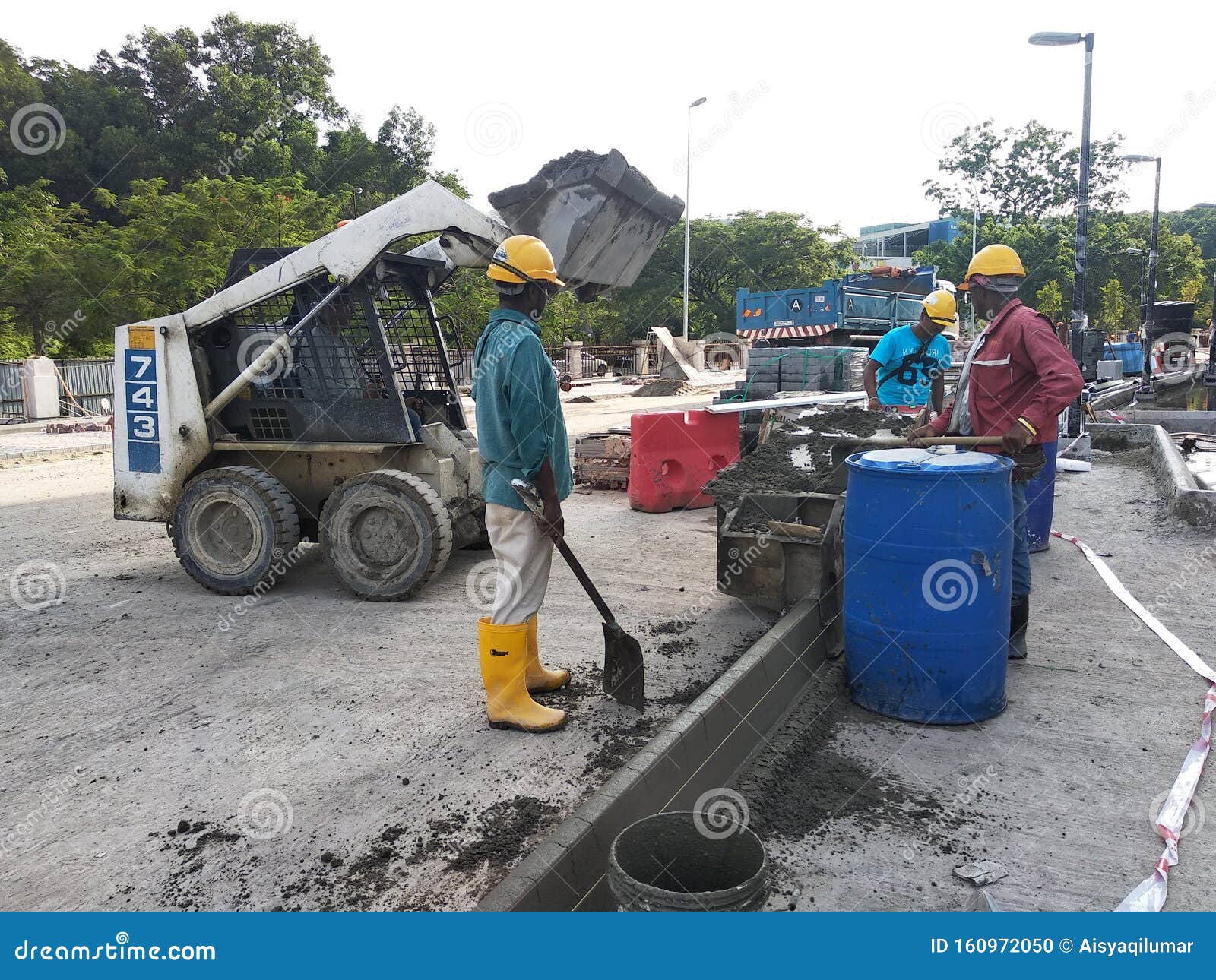 Construction Workers Creating Concrete Road Curb at the Construction ...