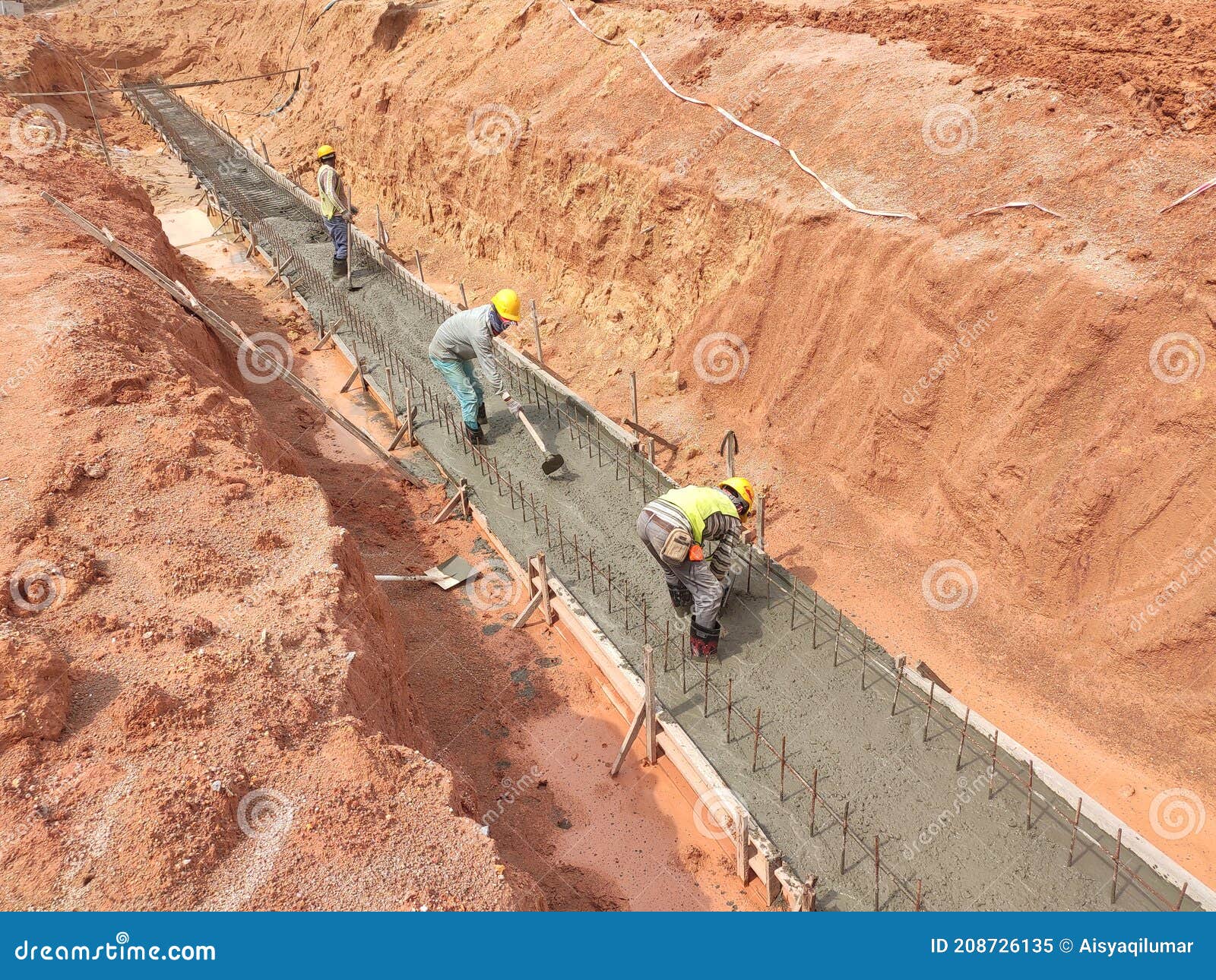 Construction Workers are Levelling a Layer of Lean Concrete in the ...