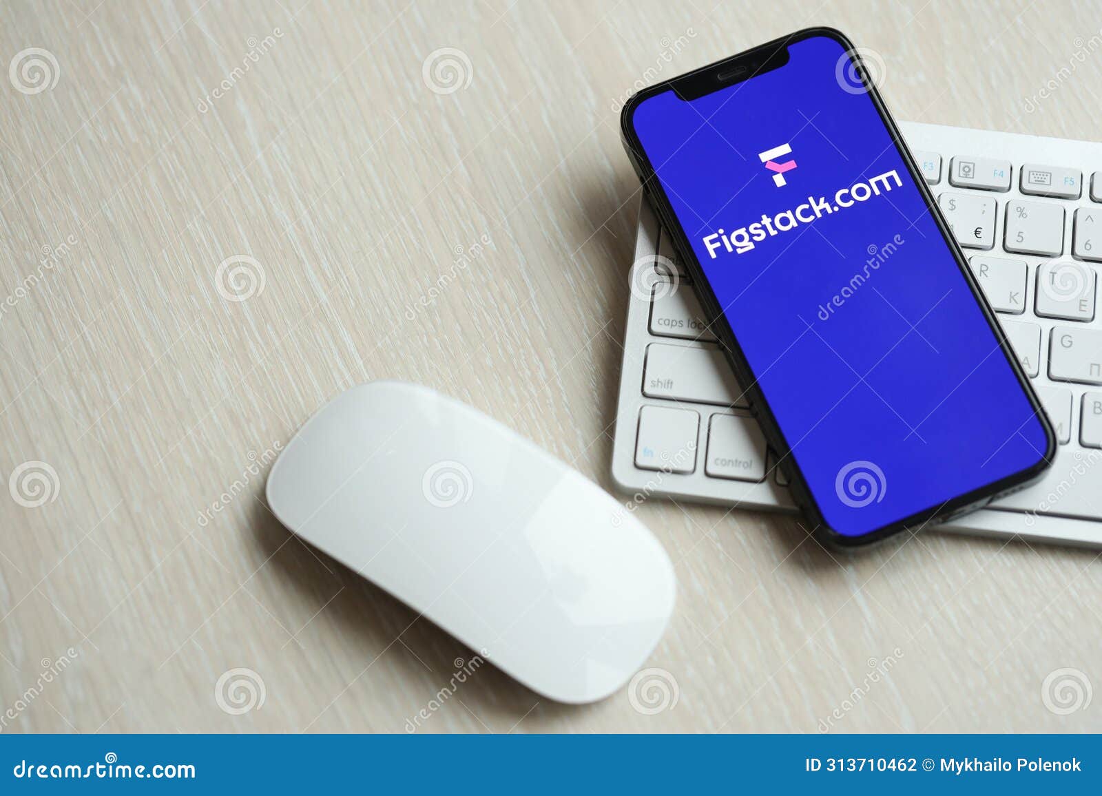 KYIV, UKRAINE - MARCH 17, 2024 Figstack Logo on IPhone Display Screen with Apple Keyboard and ...