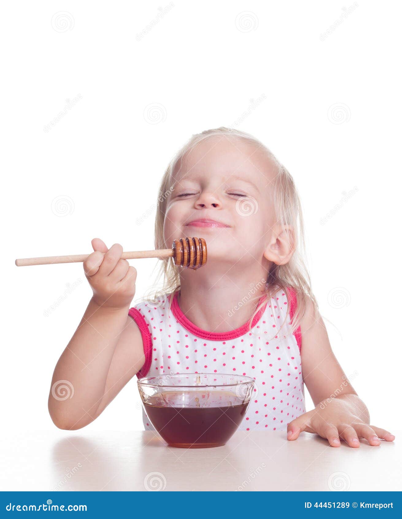 L'enfant mange du miel image stock. Image du floral, vivacité - 44451289