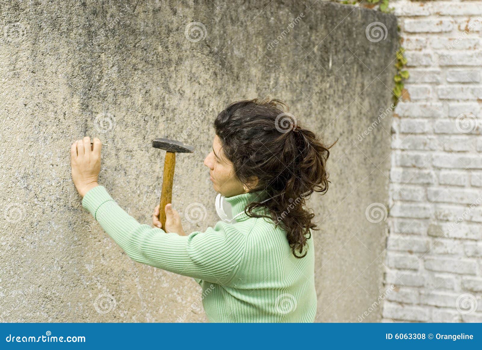 La Mujer Martilla El Clavo En La Pared - Horizontal Foto de archivo ...
