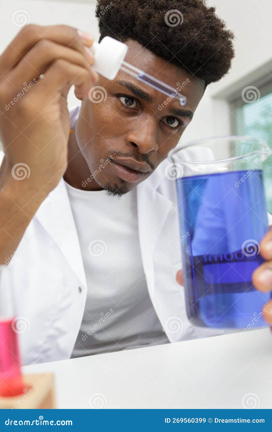 Lab-assistant in White-lab-coat Holds Laboratory Flask with Violet ...