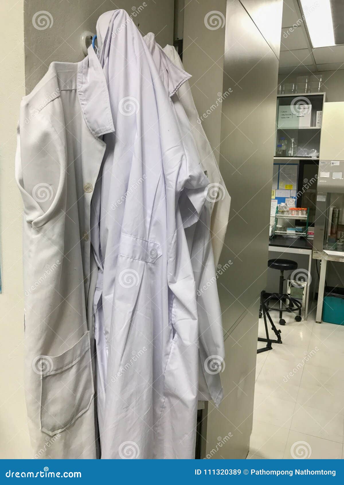 Lab coat hang on the wall stock image. Image of clean - 111320389