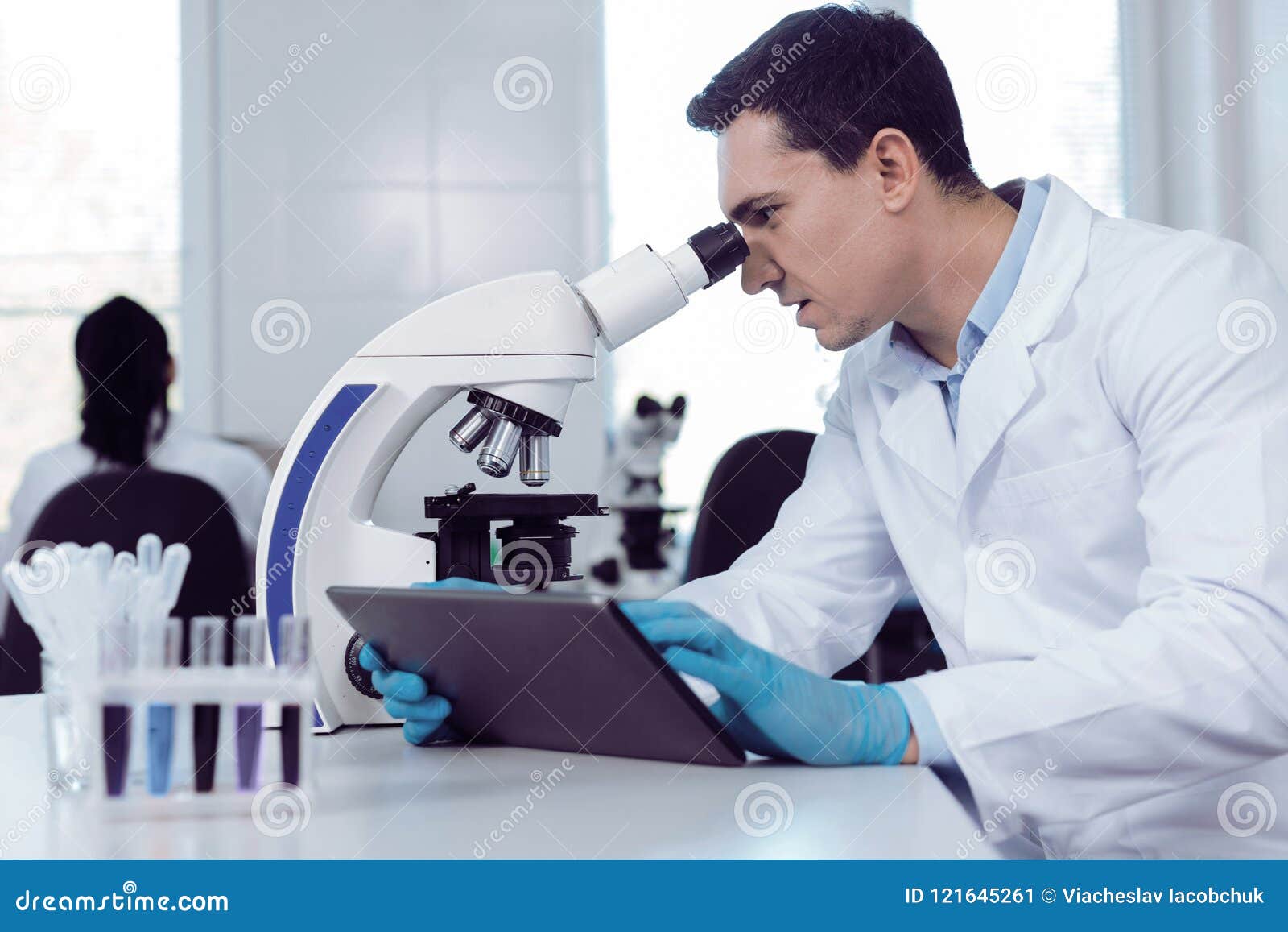 Positive Smart Scientist Looking into the Microscope Stock Image ...