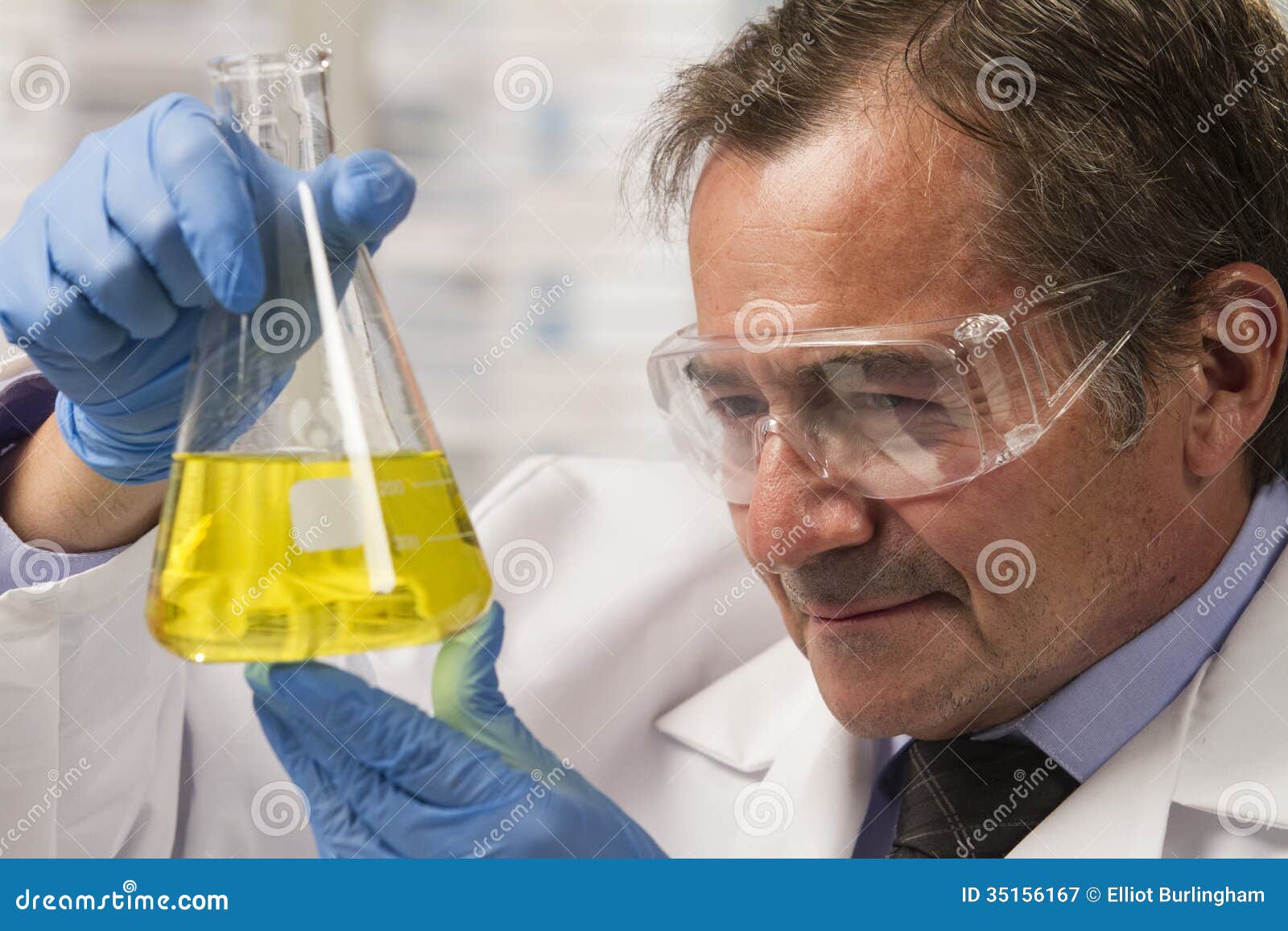 Lab Scientist Examining Beaker, Horizontal Stock Image - Image of ...