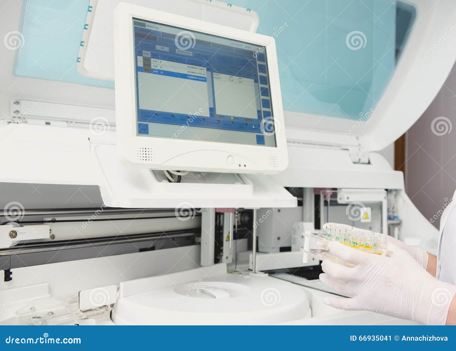 Lab Tech Loading Samples into a Chemistry Analyzer Stock Image - Image ...