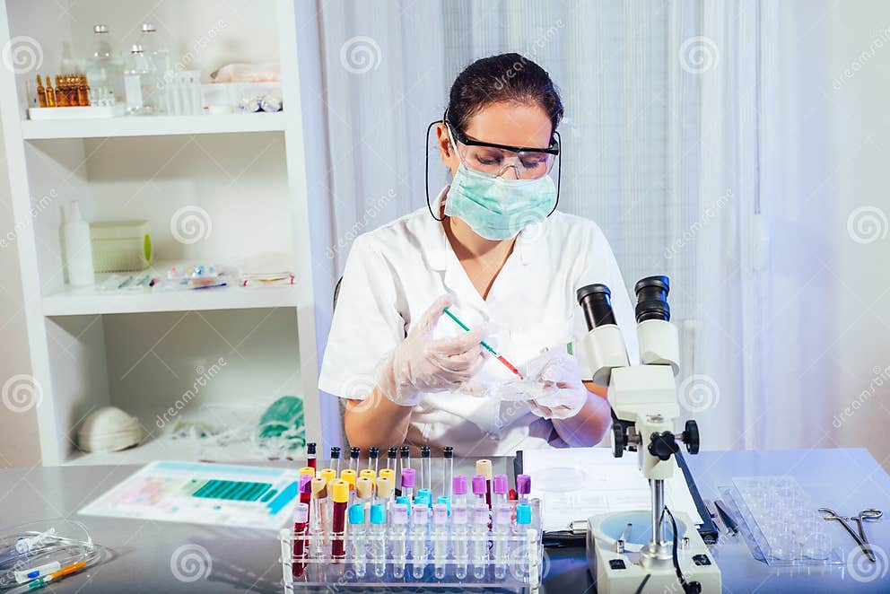 Lab Technician Assistant Analyzing a Blood Sample at Laboratory. Stock ...