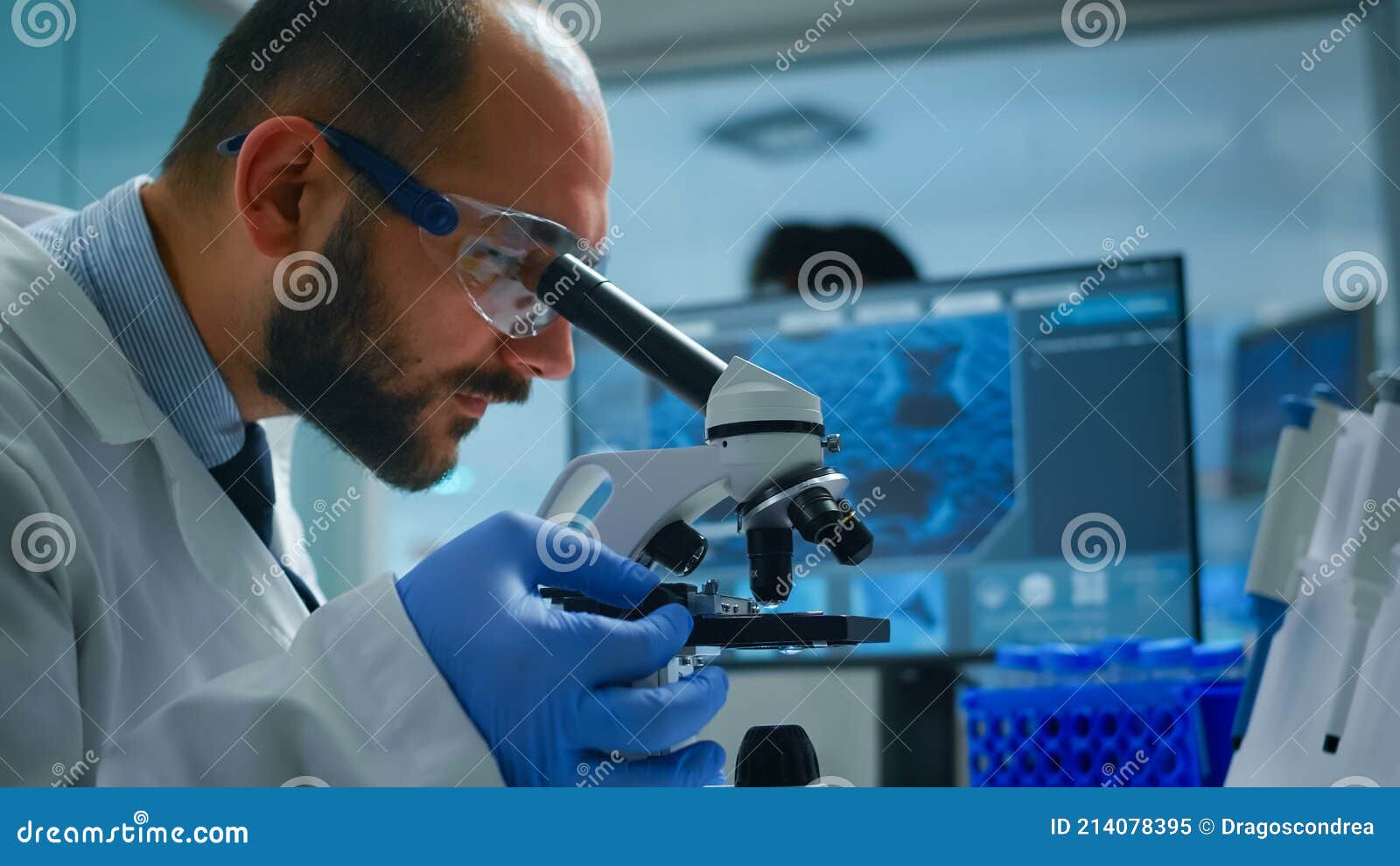 Lab Technician Examining Samples and Liquid Using Microscope Stock ...