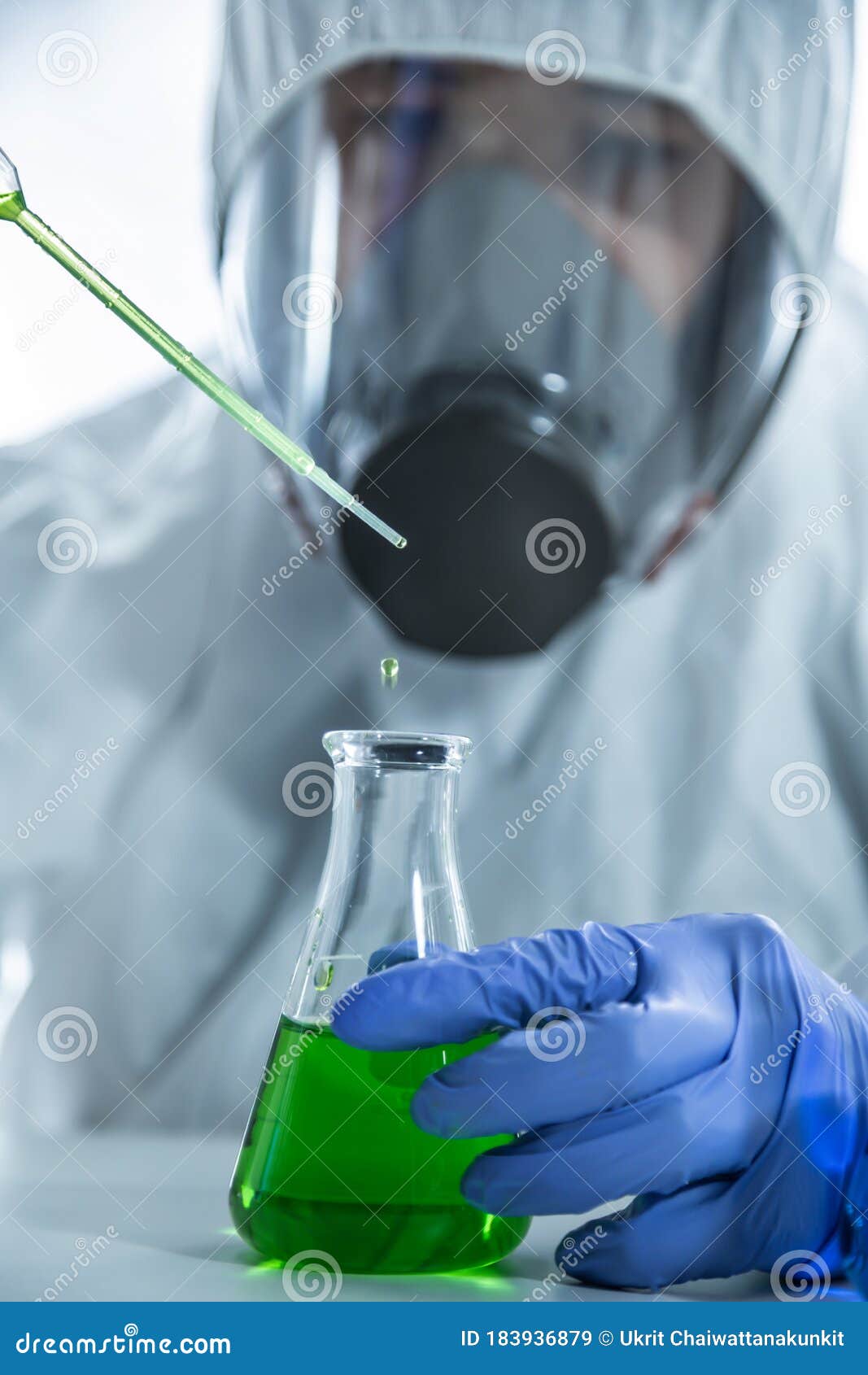 Lab Technician Holding Dropper with Dripping in Flask. Scientist in ...