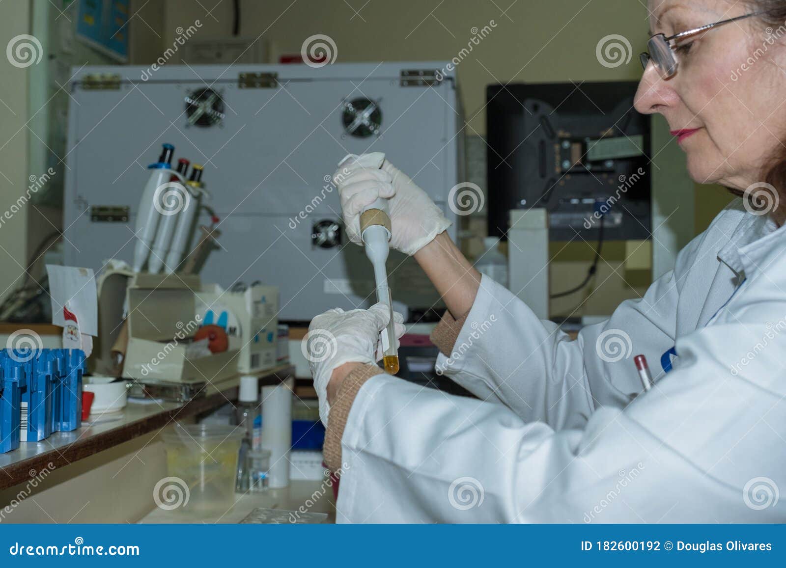 Lab Technician with a Sample of Plasma Blood Analyzing the Results ...
