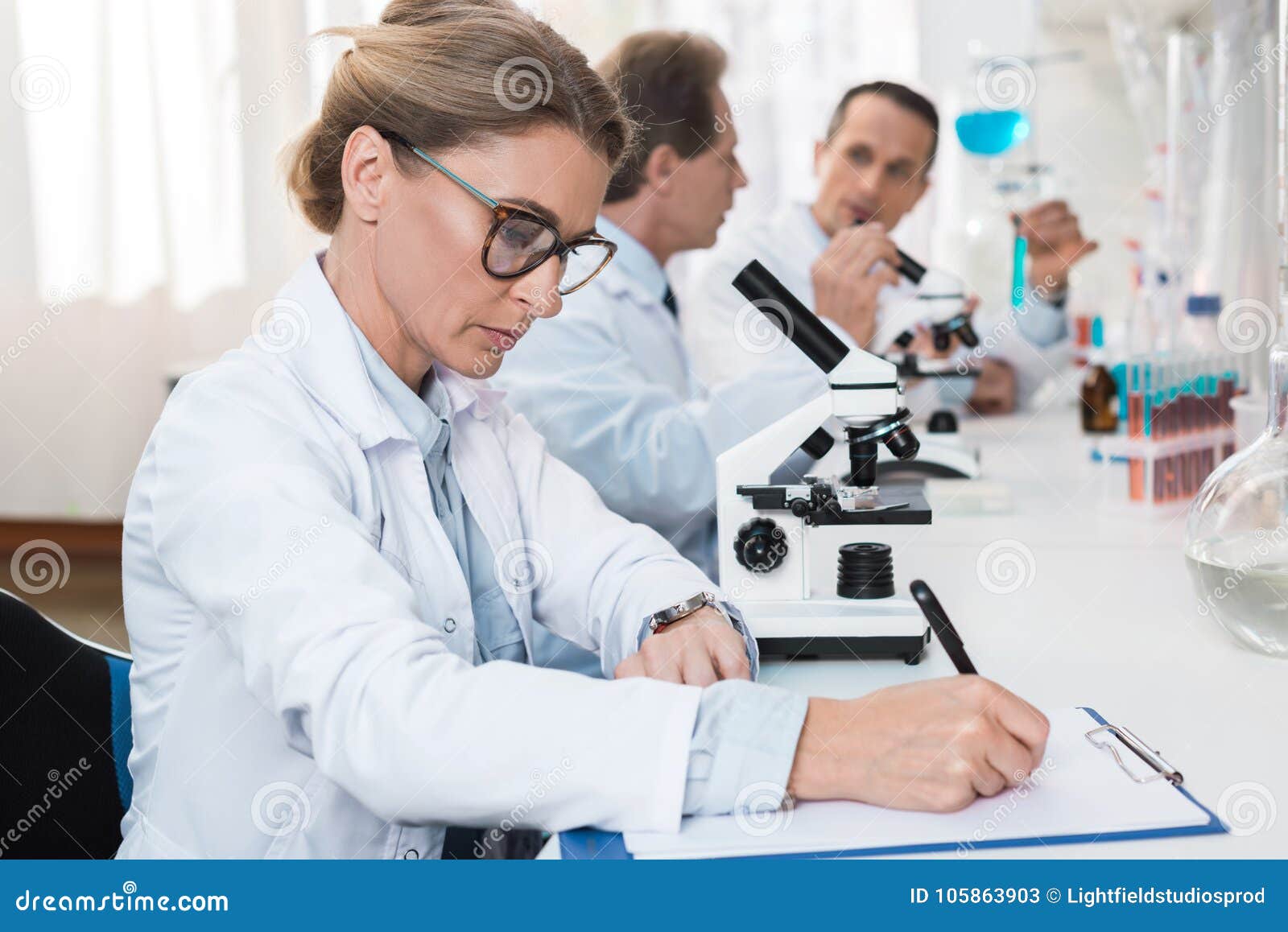 Lab Technician Taking Notes Stock Image - Image of microscope ...