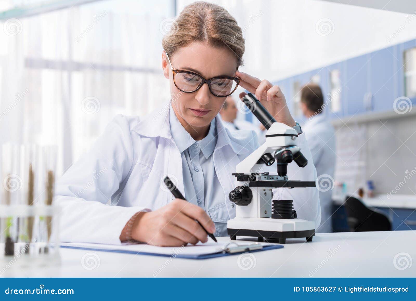 Lab Technician Taking Notes Stock Image - Image of concentrated ...