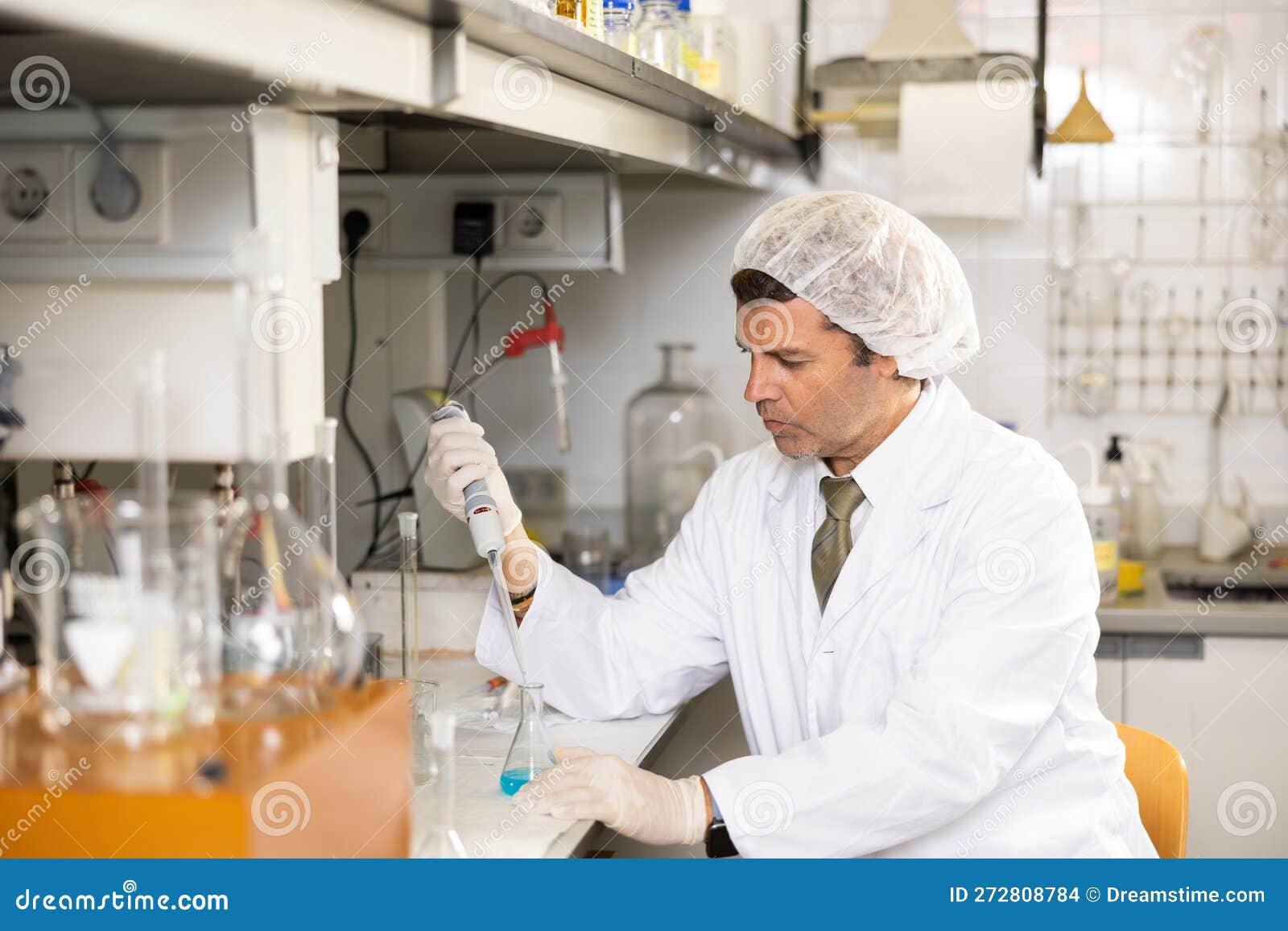Lab Technician Working with Reagents in Test Tubes during Chemical ...